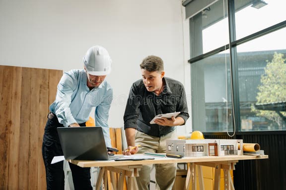 Professional Collaboration in Architecture. Two Engineers Work on ...
