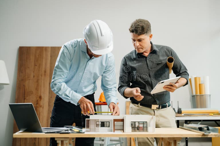 Professional Collaboration in Architecture. Two Engineers Work on ...