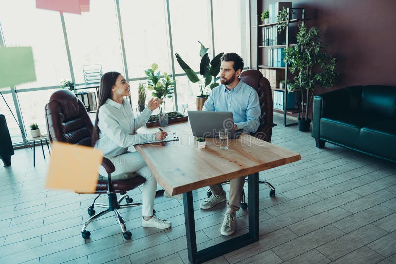 Professional Colleagues Discussing Project Ideas at Workspace Desk in ...
