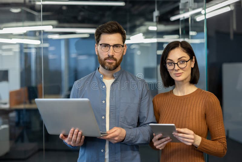 Professional Colleagues Standing Confidently in Modern Office Holding ...