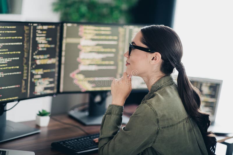 Professional Computer Programmer Analyzing Code on Multiple Monitors in ...