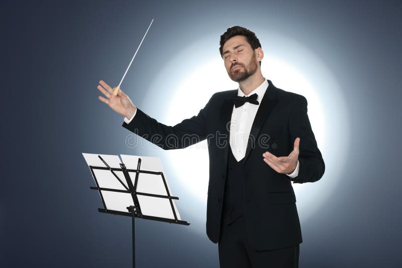 Professional Conductor with Baton and Note Stand on Grey Background ...