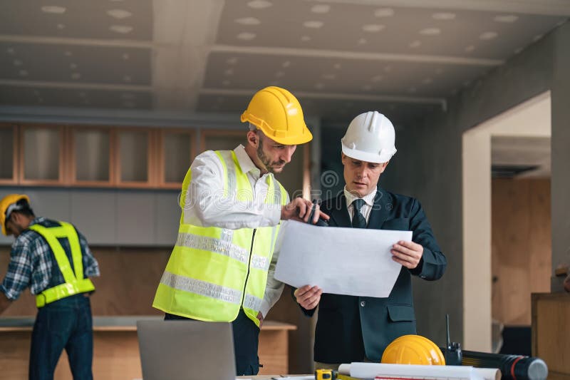 Professional Construction Engineers Team Using Blueprint of Project ...