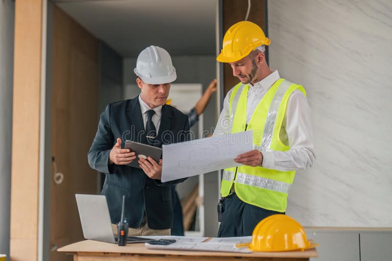 Professional Construction Engineers Team Using Blueprint of Project ...