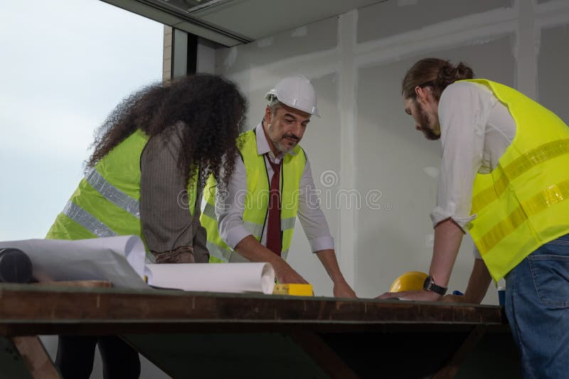 Professional Construction Engineers Team Using Blueprint of Project ...