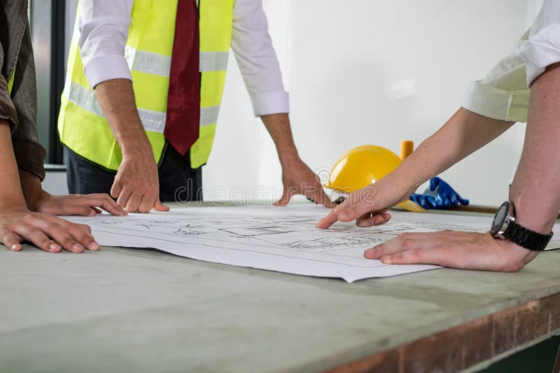 Professional Construction Engineers Team Using Blueprint of Project ...