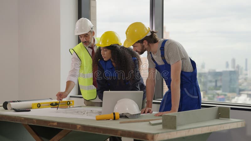 Professional Construction Engineers Team Using Blueprint of Project ...