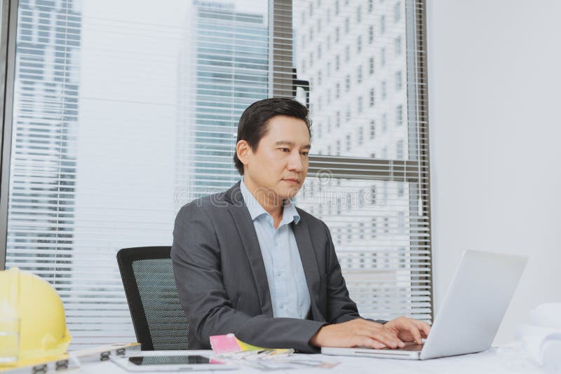 Professional Construction Manager Working with Blue Print in Off Stock ...