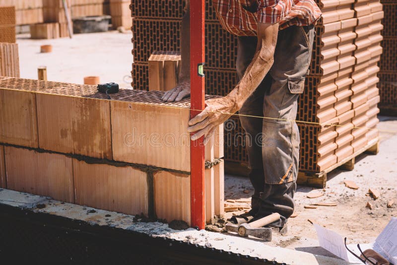 Professional Construction Worker Adjusting Bricks and Mortar - Building ...