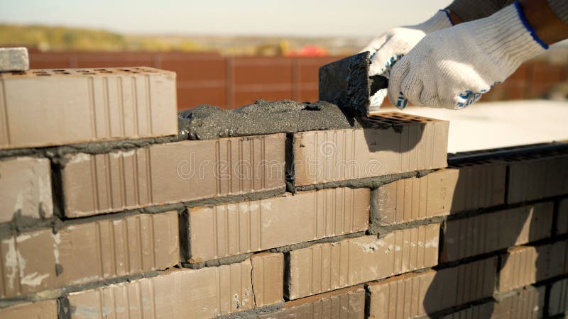 Construction Worker Building a Brick Wall. Professional Construction ...