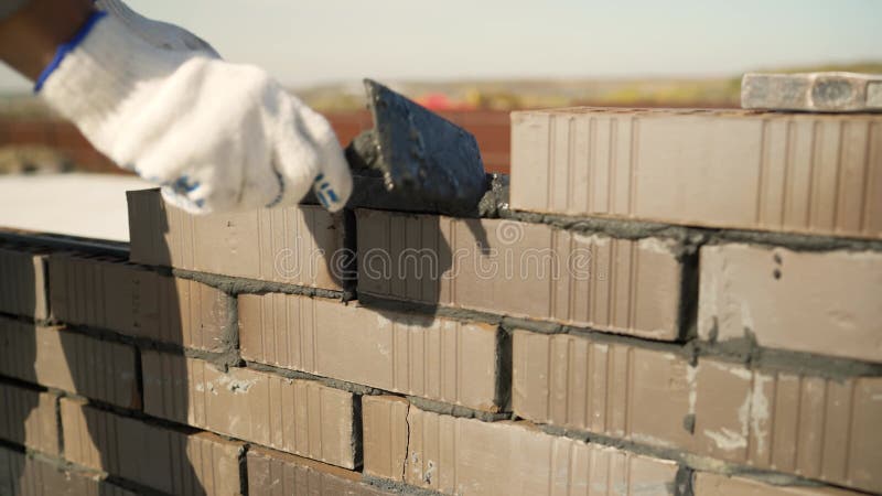 Construction Worker Building a Brick Wall. Professional Construction ...