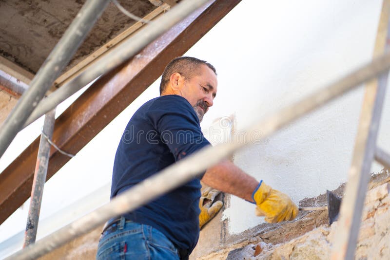 Construction Worker on a Ladder Fixing a Wall Stock Image - Image of ...