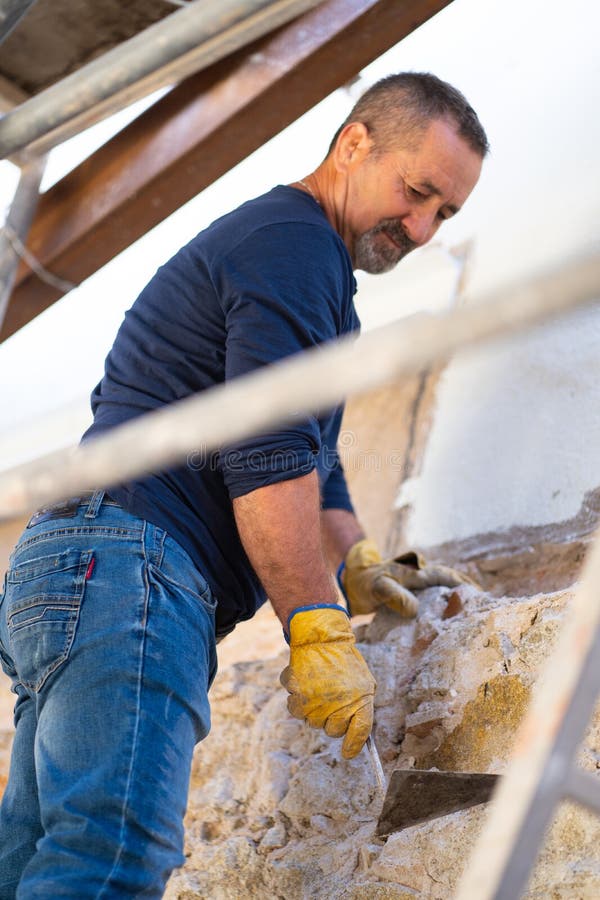 Construction Worker on a Ladder Fixing a Wall Stock Image - Image of ...