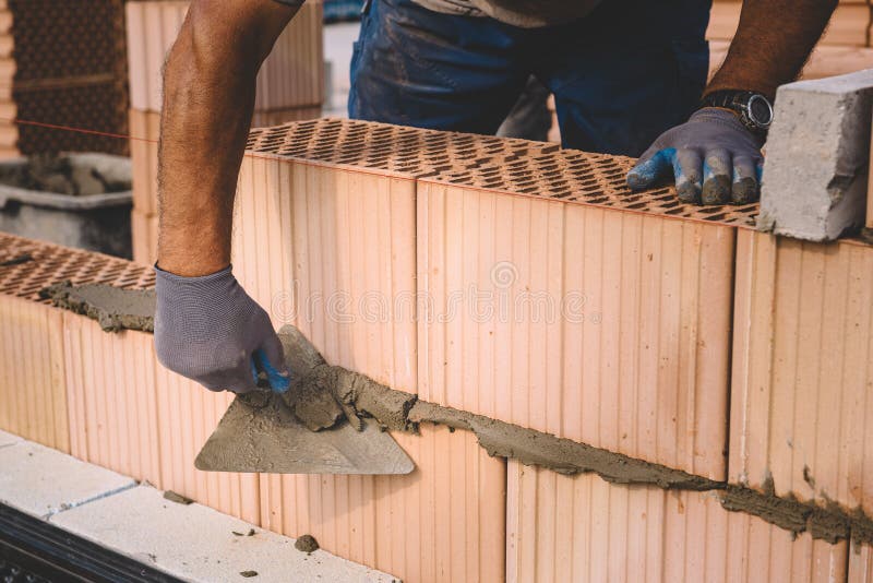 Professional Construction Worker Laying Bricks and Mortar - Building ...