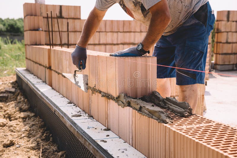 Professional Construction Worker Laying Bricks and Mortar - Building ...