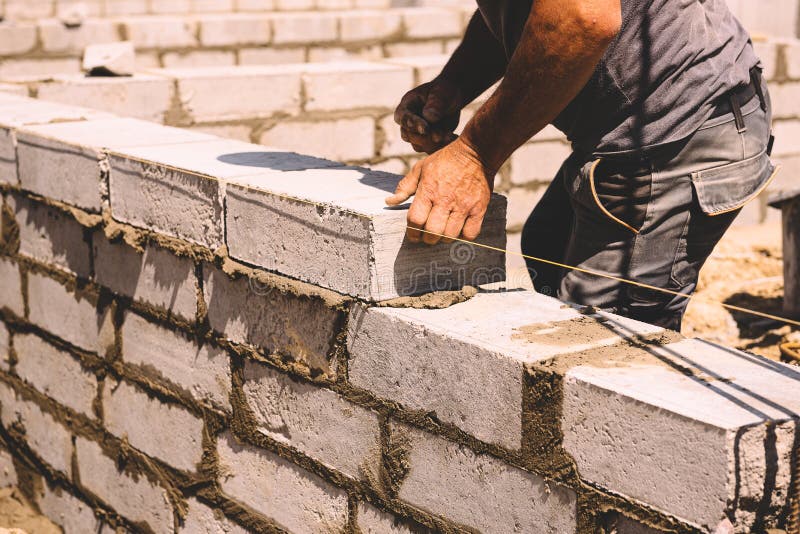 Professional Construction Worker Laying Bricks and Mortar - Building ...
