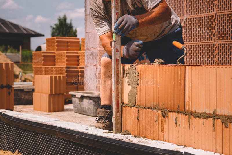 Professional Construction Worker Laying Bricks and Mortar - Building ...