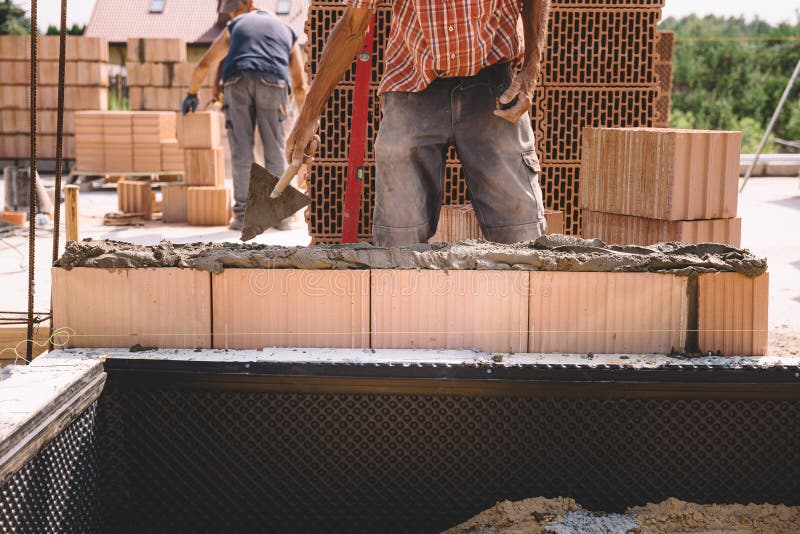 Professional Construction Worker Laying Bricks and Mortar - Building ...