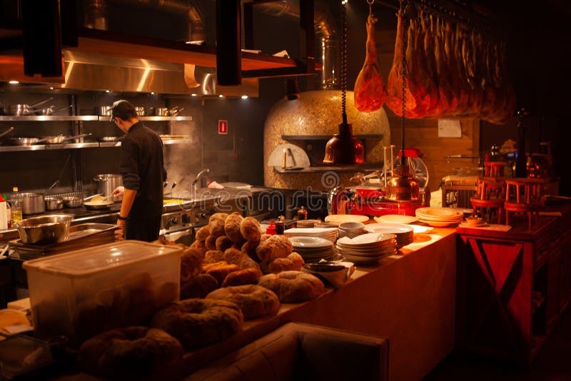 Professional Cook. Chef in Black Apron and Cap Working in Restaurant ...