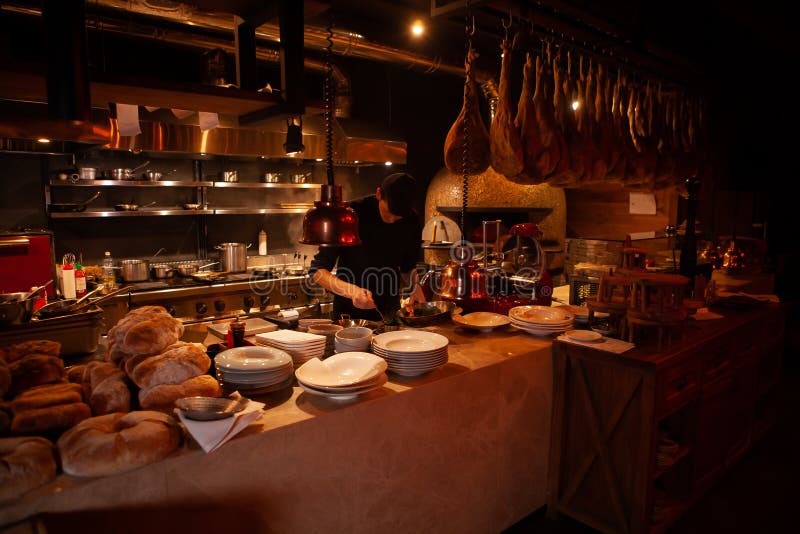 Professional Cook. Chef in Black Apron and Cap Working in Restaurant ...