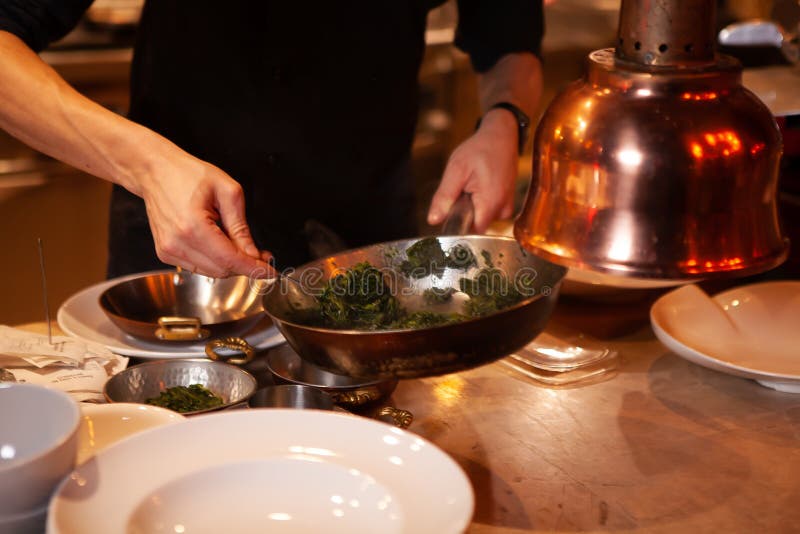 Professional Cook. Chef in Black Apron and Cap Working in Restaurant ...