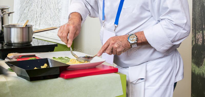 Professional Cook, Dressed in White and Preparing a Well Balanced ...
