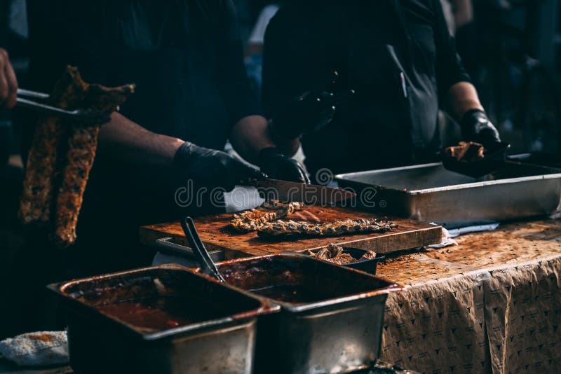 Professional Cooks Dressed in Black Making Delicious Ribs in the ...