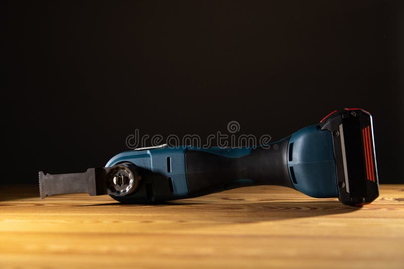 A Professional Cordless Oscillating MultiTool Cutter Placed on a Wooden ...