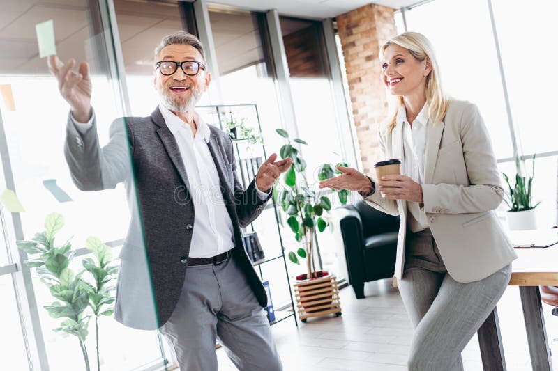 Professional Coworkers Discussing a Project in a Bright Office ...