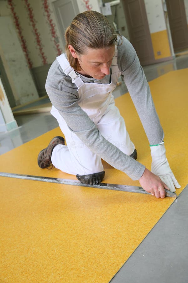 Professional Craftsman Installing Plastic on Floor Surface Stock Image ...