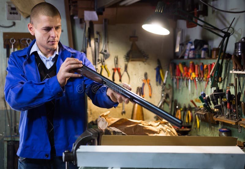 Professional Craftsman Repairing and Assembling Shotgun in Weapons ...