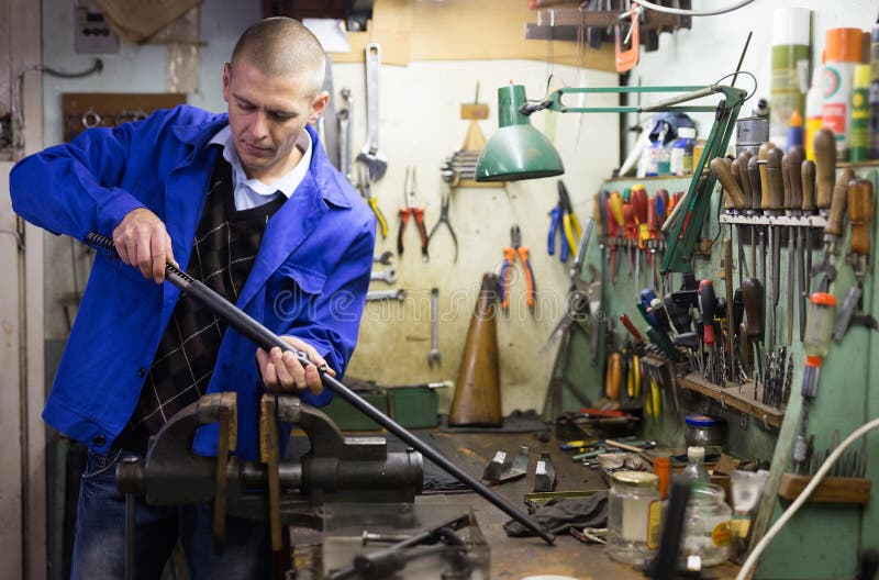 Professional Craftsman Repairing and Assembling Shotgun in Weapons ...