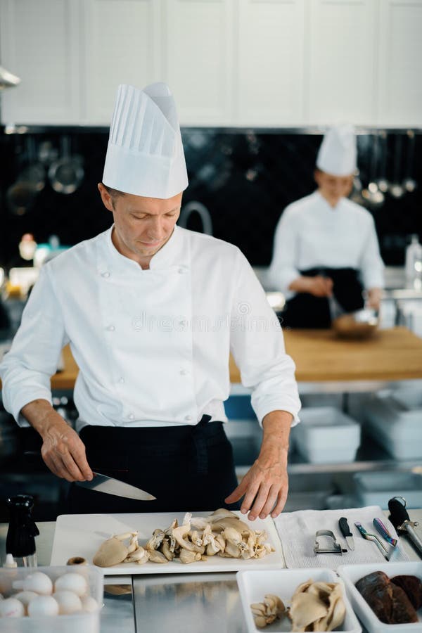 Professional Cuisine: Two Chefs Prepare a Delicious Dish in a ...