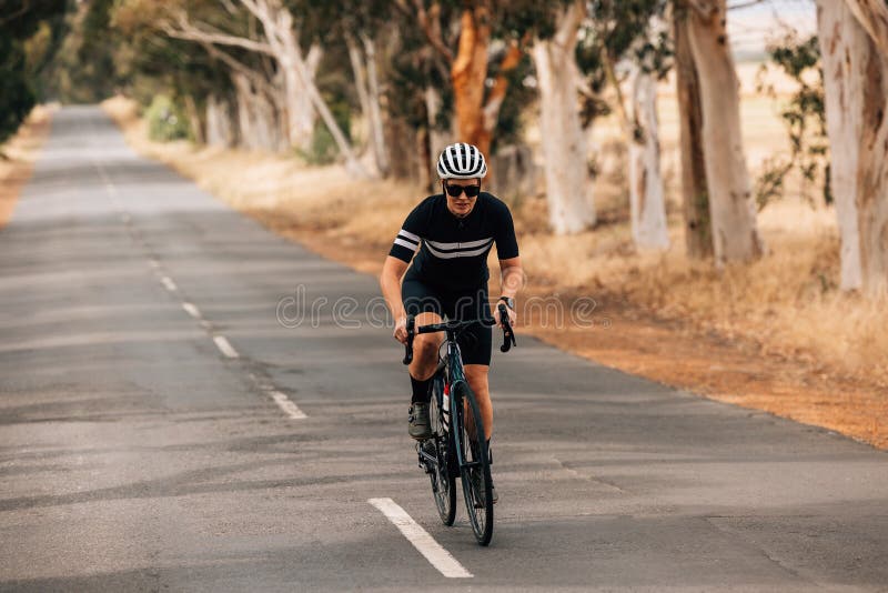 Professional Cyclist Riding Her Bike on Empty Road Stock Image - Image ...