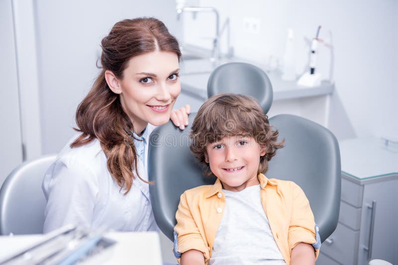 Professional Dentist and Little Boy in Dentist Office Stock Image ...