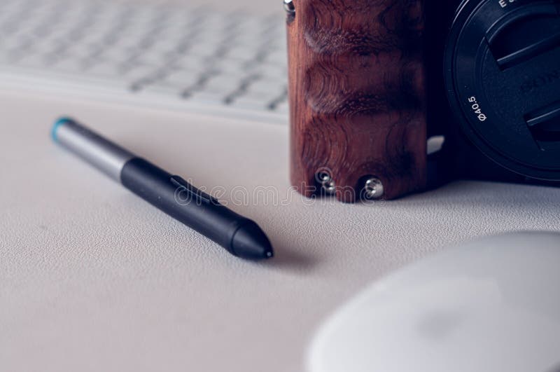 A Camera and Keyboard on the Desk with a Mouse and a Pen Editorial ...