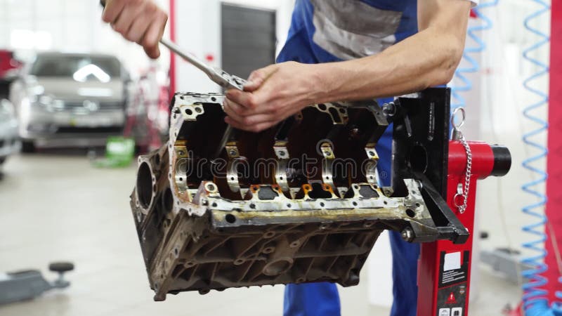 Auto Mechanic Disassembles Car Engine at Modern Workshop. Professional ...