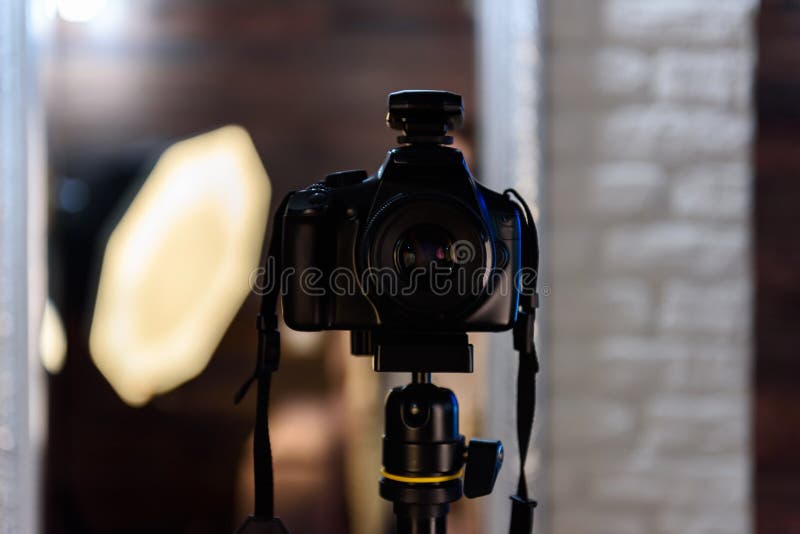 Professional Digital Camera on a Tripod Connected by a Synchronizer To ...