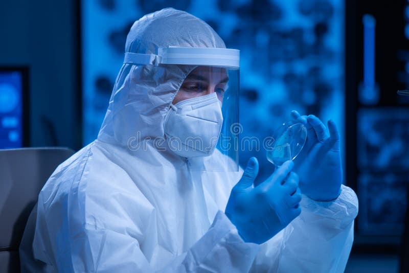 Doctor in Protective Suit is Doing a Science Experiments and Developing ...