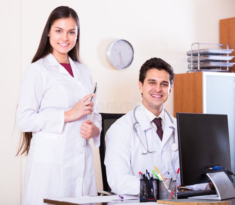 Professional Doctors Smiling in Clinic Stock Photo - Image of caucasian ...