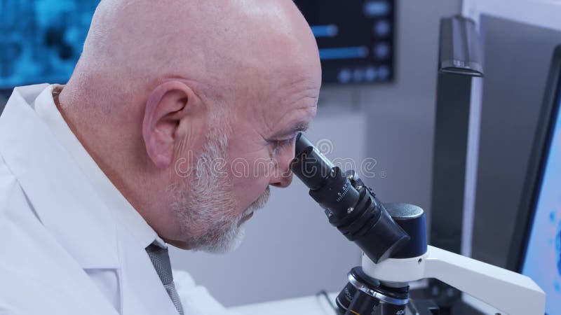 Elderly Professor is Doing a Science Experiment in a Modern Laboratory ...