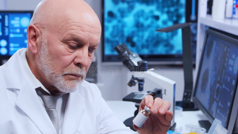 Elderly Professor is Doing a Science Experiment in a Modern Laboratory ...
