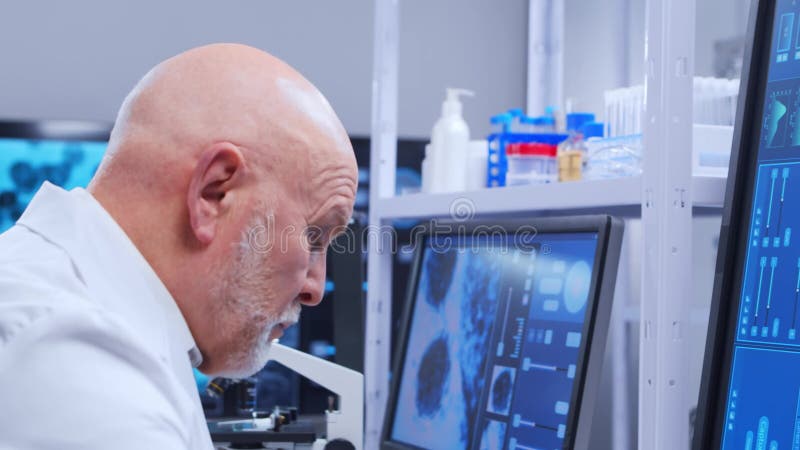 Elderly Professor is Doing a Science Experiment in a Modern Laboratory ...