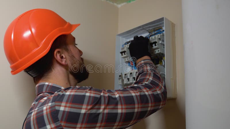 Electrician Installing Electrical Panel in Office or House Stock ...