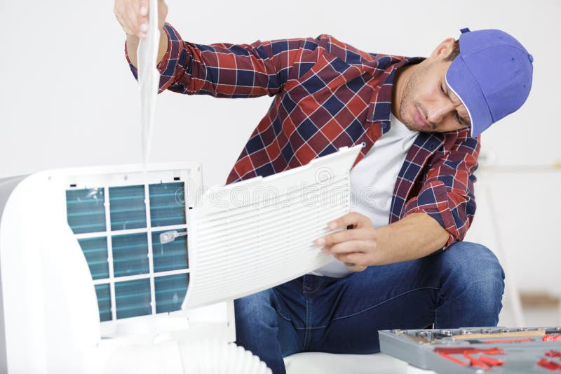 Professional Electrician Man Fixing Heavy Air Conditioner Stock Photo ...