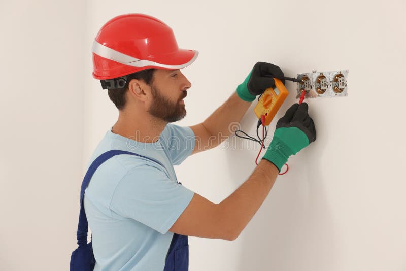 Professional Electrician with Tester Checking Voltage Indoors Stock ...