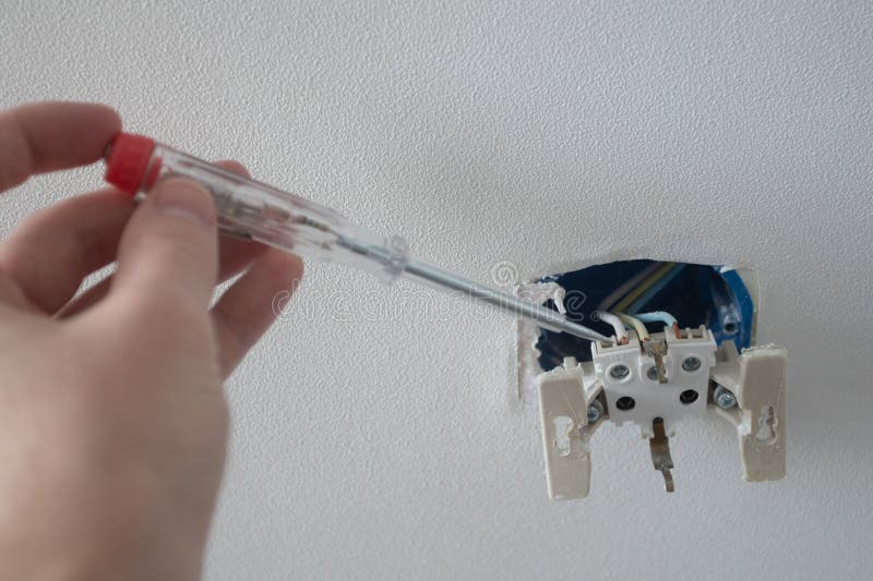 Professional Electrician Working on a Home Electrical System, he is ...