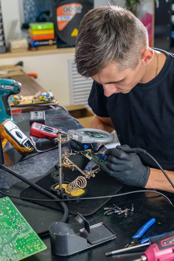 Professional Electronic Technician Repairing Equipment in a Service ...