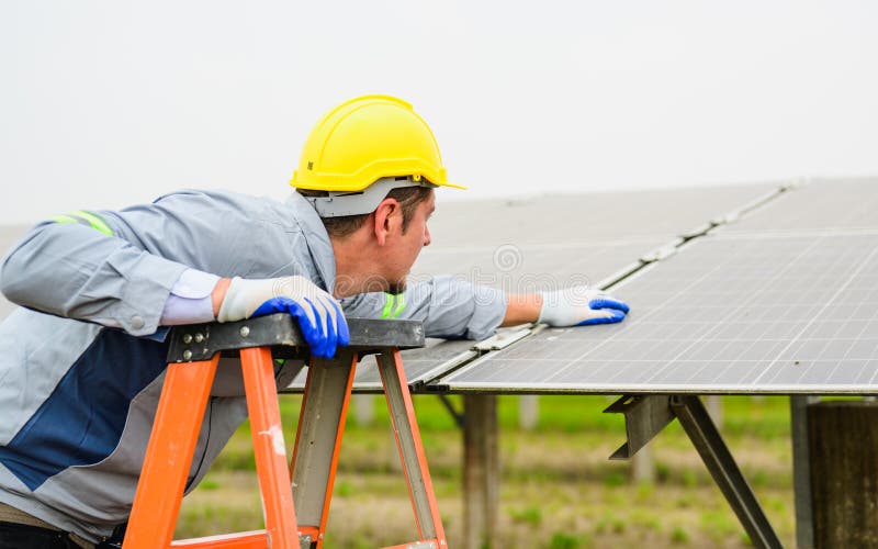 Professional Engineer Checking and Maintaining Solar Panels on Solar ...