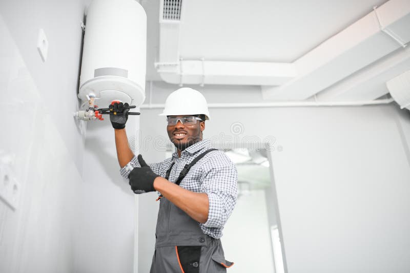 Professional African American Engineer Doing a Boiler Inspection at ...